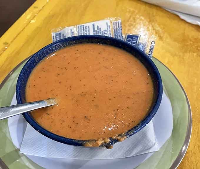 Tomato soup in a speckled blue bowl, the kind of simple comfort that reminds you why diners matter in this world.