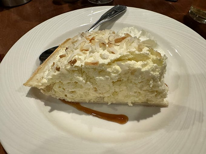 Coconut cream pie towering with meringue and toasted coconut, the perfect sweet finale to your seafood symphony.