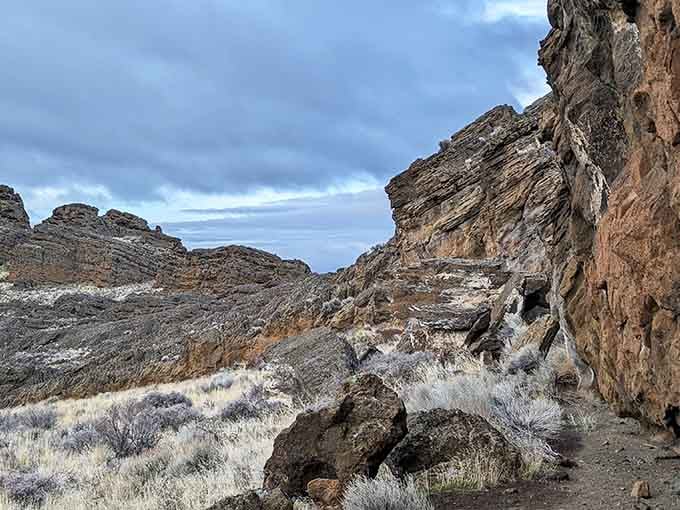 These layered volcanic walls tell stories of explosive encounters between molten rock and an ancient lake.