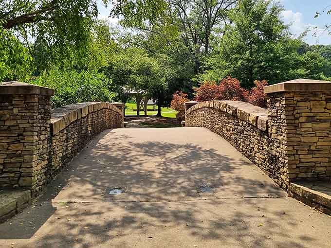Stone bridges connect different worlds within the park, each crossing feeling like a small adventure unto itself.