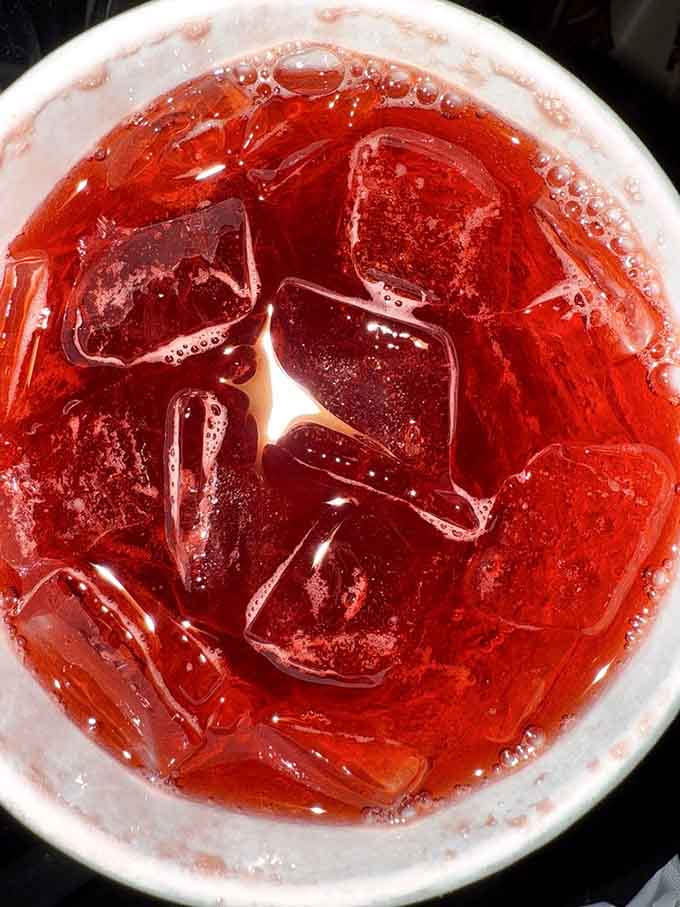 Bright red and ice-cold, this drink provides essential cooling relief between bites of smoky perfection.