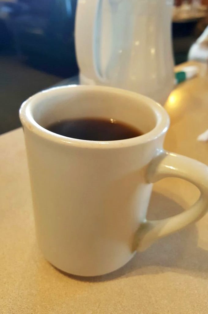 Coffee served in a proper mug, hot and strong enough to wake up three generations of your family tree.