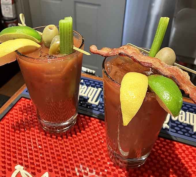 Bloody Marys garnished like they're ready for their close-up, complete with bacon because vegetables alone never tell the whole story.