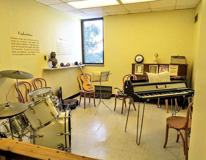 Musical instruments on display show how therapeutic activities evolved, offering patients creative outlets beyond just medical interventions and confinement.