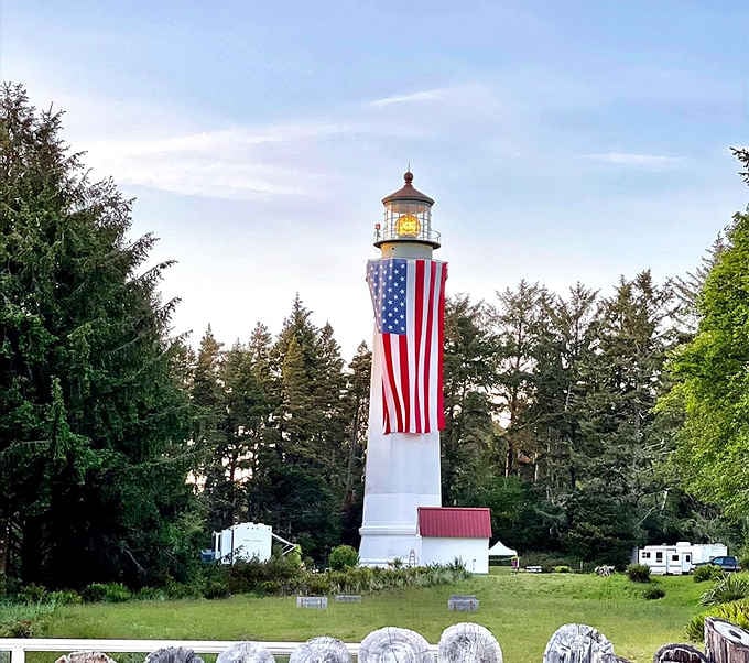 Old Glory draped down the tower transforms this working lighthouse into a patriotic beacon visible for miles around the coast.