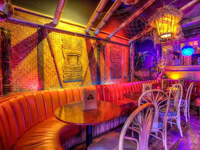 Orange vinyl booths beneath towering tikis create the perfect backdrop for an unforgettable evening out together.