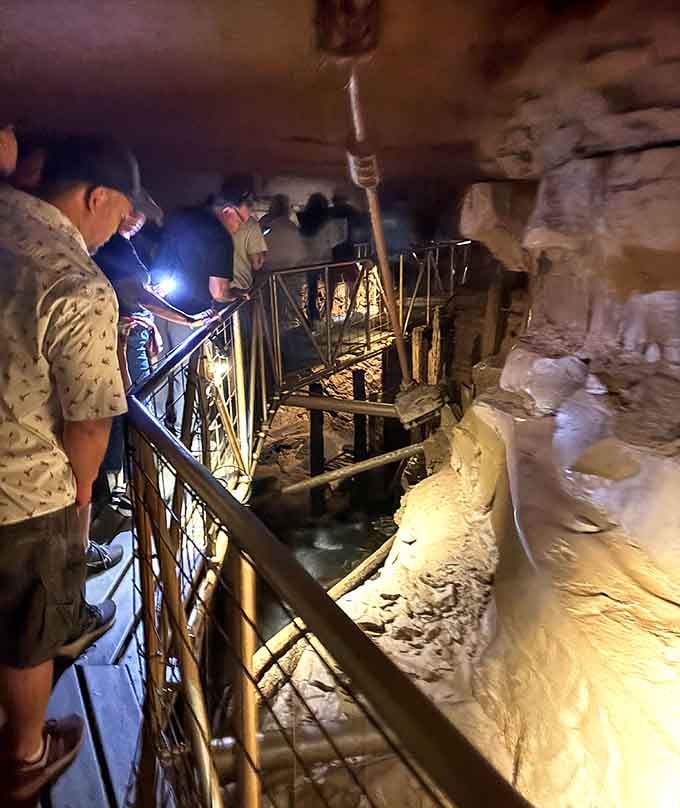 Tour groups gather along the underground pathways, flashlights in hand, ready to explore the restored river system flowing beneath them.
