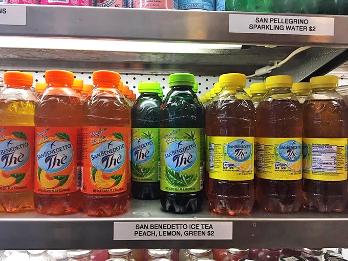 San Benedetto iced teas lined up like colorful soldiers, ready to battle the thirst that inevitably follows your encounter with Faicco's salt-cured Italian meats.