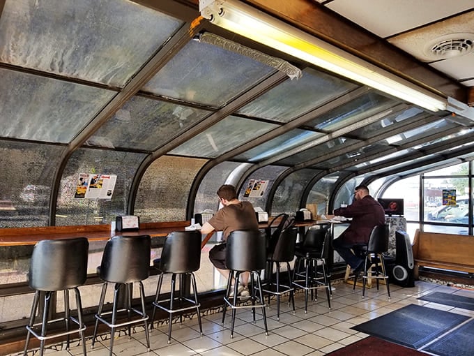 The curved counter seating area offers front-row views to Paducah life unfolding, where solo diners never really eat alone in this hub of local conversation.