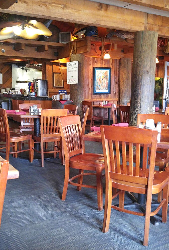 The dining room's warm wooden interior feels like you've stepped into a cozy fishing lodge where every table promises a memorable meal.