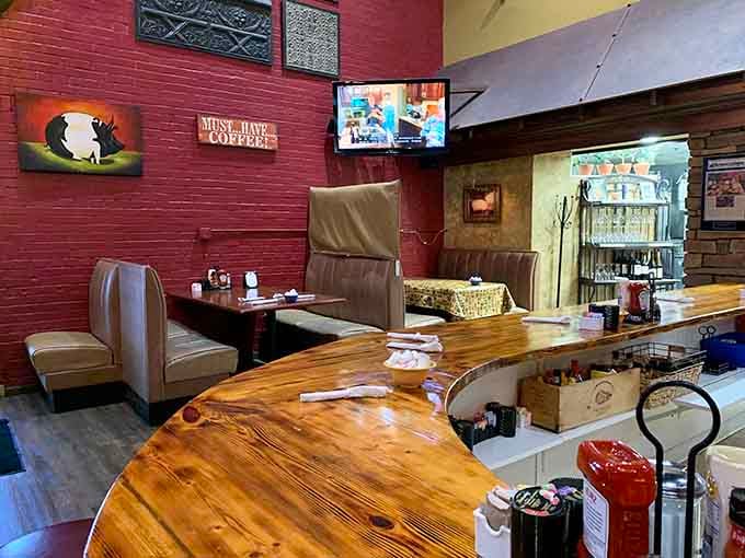 The cozy interior features wooden countertops and comfortable seating that says, "We're serious about comfort food." That "Must Have Coffee" sign speaks the universal morning language.