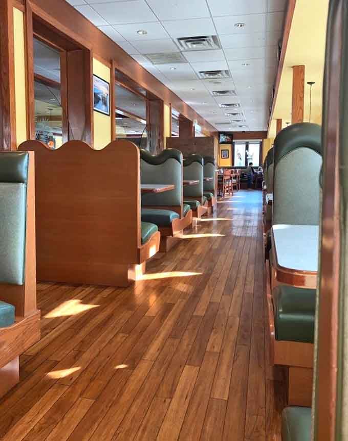 Those green booths and wood dividers create cozy dining spaces perfect for lingering over coffee and conversation with friends.