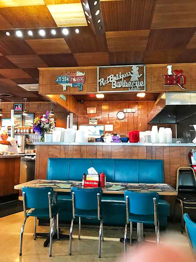 Wood paneling, blue booths, and that checkered ceiling&mdash;a time capsule of American dining where the food matters more than the Instagram lighting.