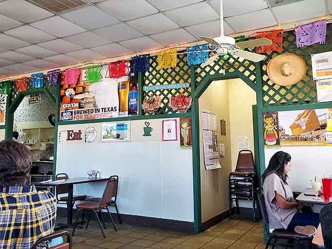 The lattice dividers and festive decorations aren't from some corporate design manual&mdash;they're the accumulated personality of years serving the neighborhood.