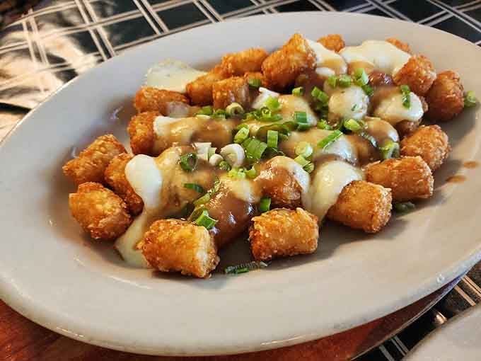Tater tots elevated to gourmet status with toppings that transform childhood nostalgia into adult indulgence.