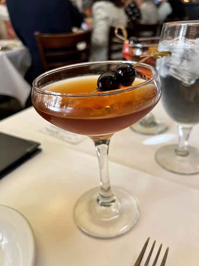 That Malachi Manhattan with bourbon cherries looks like liquid sophistication decided to take the evening off and relax properly.