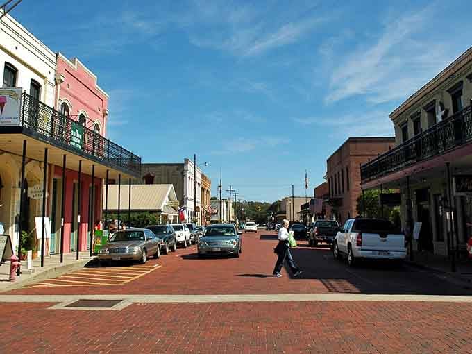Pedestrians crossing brick streets between buildings that have stood watch over this town for generations.
