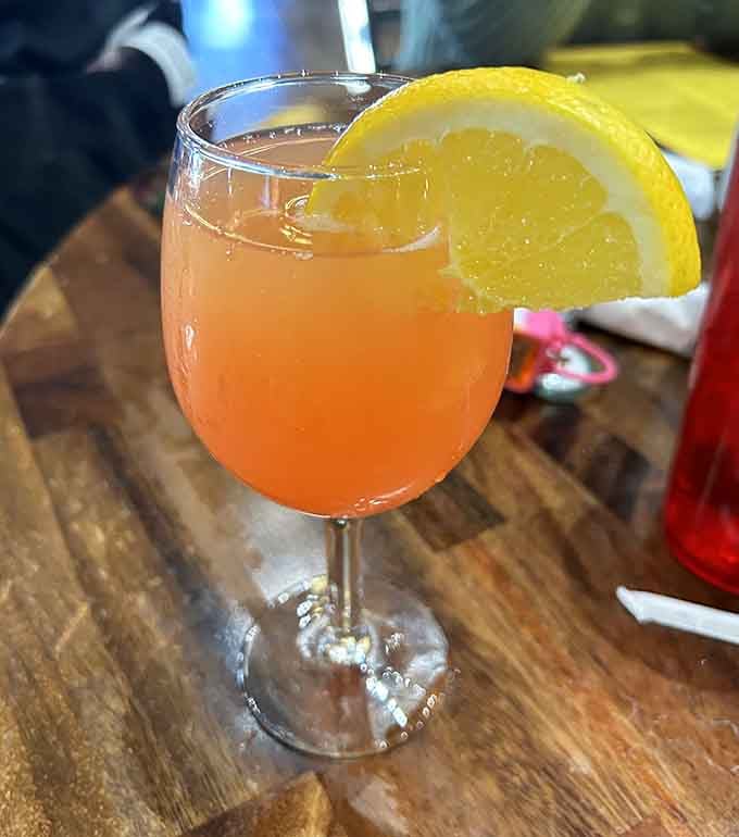 That mimosa with its cheerful citrus garnish is proof that breakfast can be both civilized and celebratory.