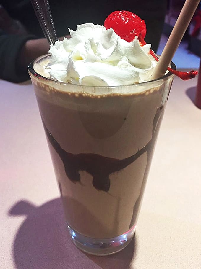Topped with whipped cream and a cherry, this chocolate shake is thick enough to require commitment and a spoon.