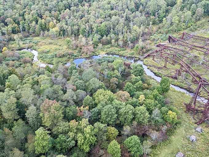 From the valley floor, the remaining bridge towers stand like monuments to human ambition and determination.