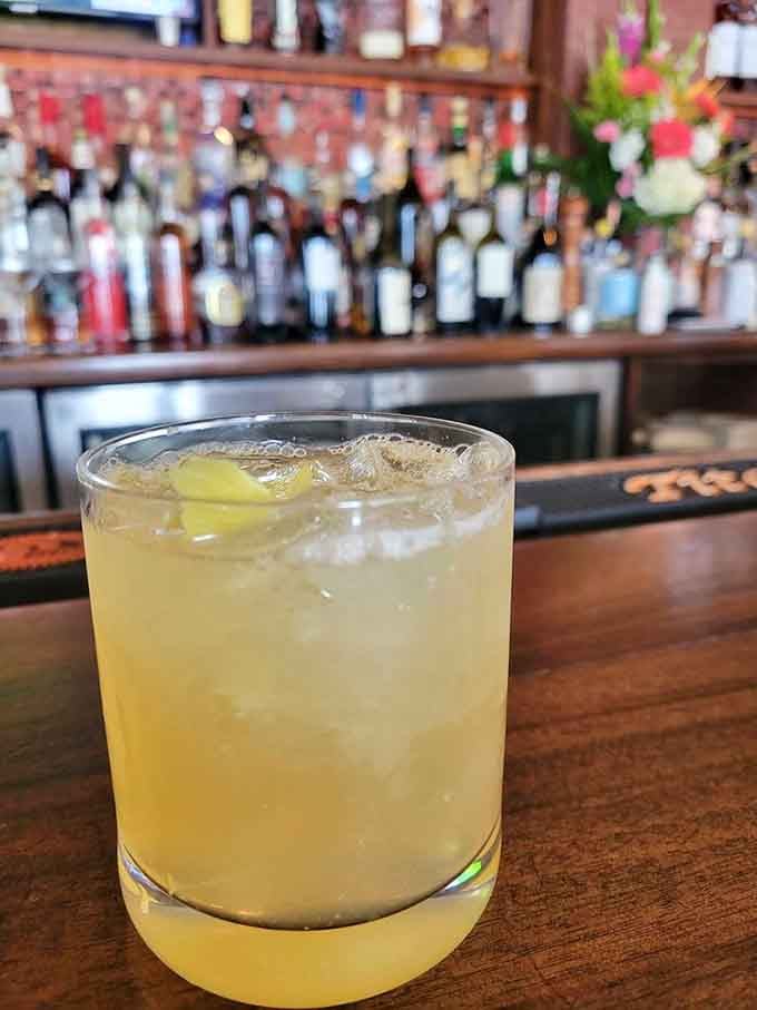 The Bee's Knees cocktail glows like liquid sunshine, proving Prohibition-era drinks still hold up a century later.