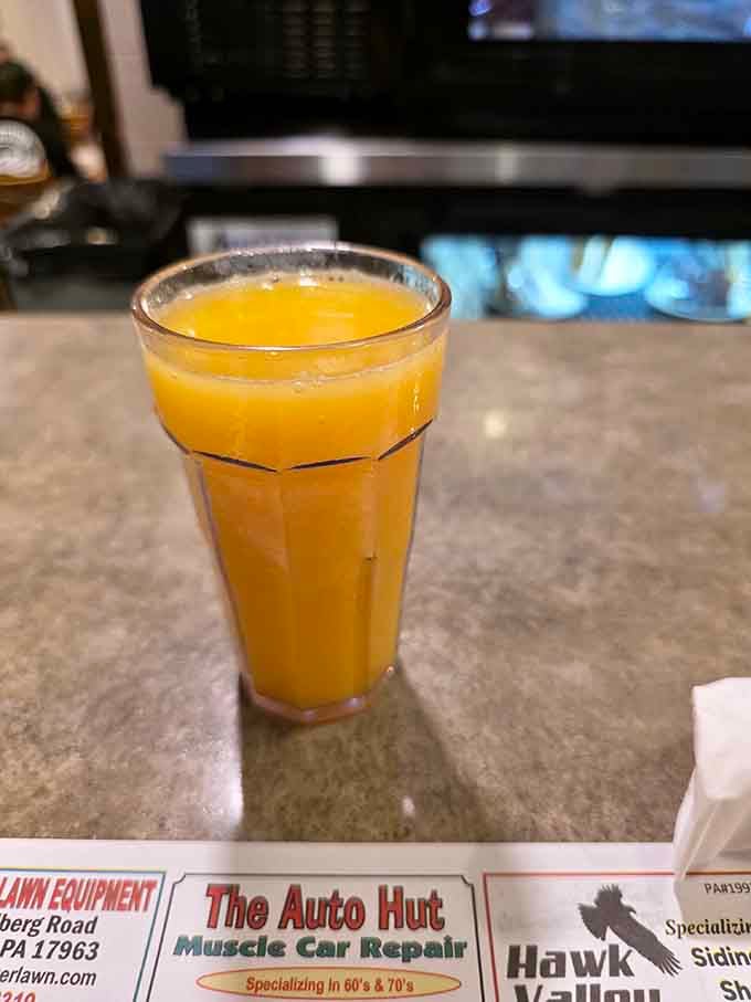 Fresh orange juice in a proper glass, because even the simple things deserve to be done right and served with care.
