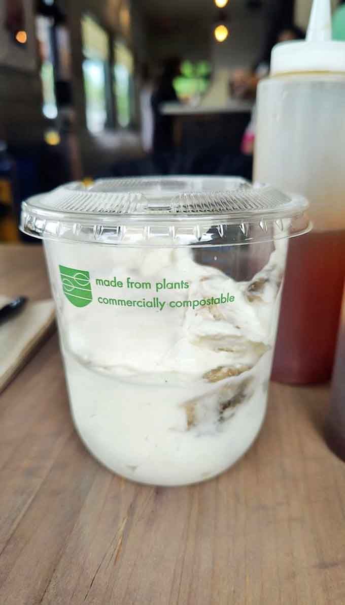 Banana pudding in a compostable cup, because even eco-friendly packaging can't diminish the joy of this classic Southern dessert.