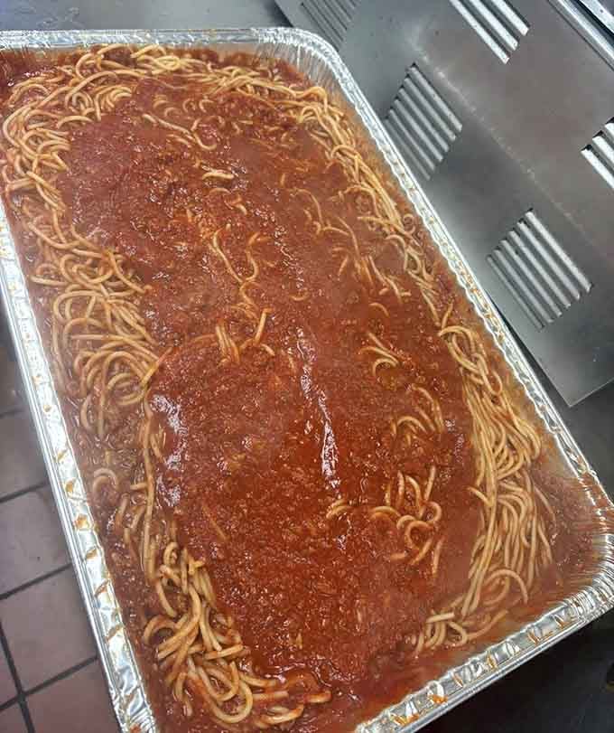 This aluminum tray of spaghetti contains enough pasta to understand why Italians gesture so much when they talk about food.