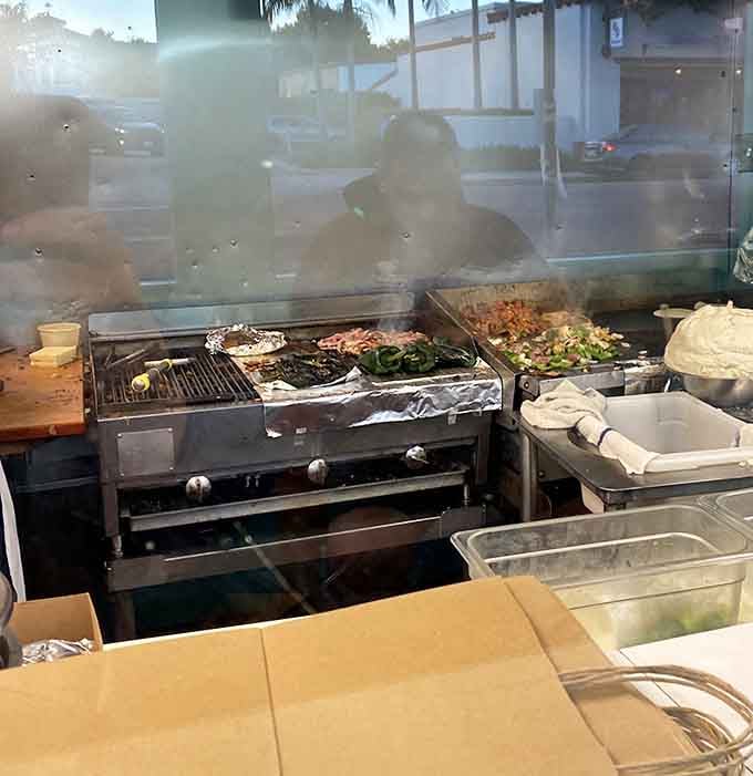 The open kitchen where magic happens, with grills working overtime to feed the faithful masses outside.