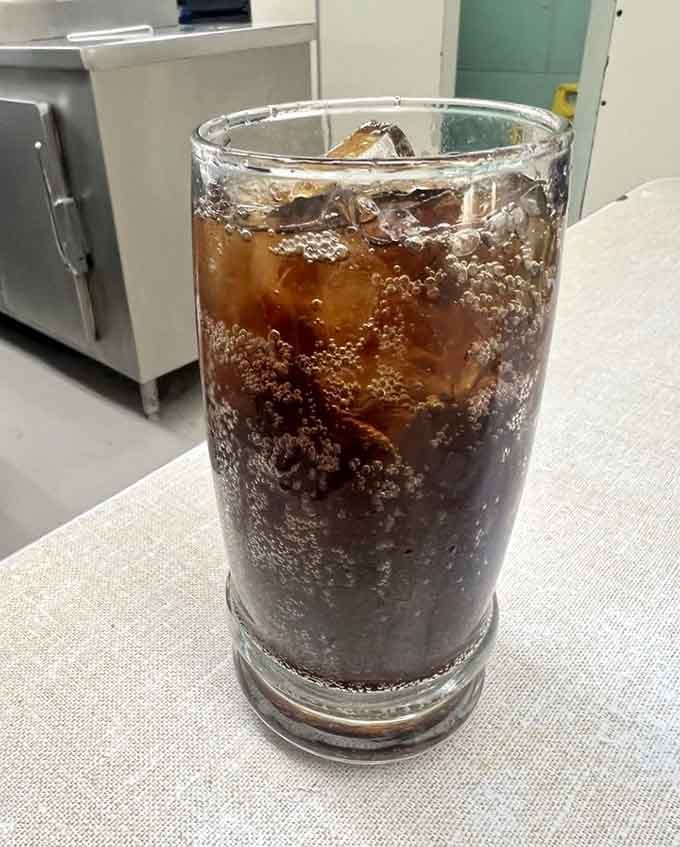 Ice-cold soda with perfect carbonation bubbles, the classic diner beverage that completes your authentic Lafayette experience like Sinatra and martinis.