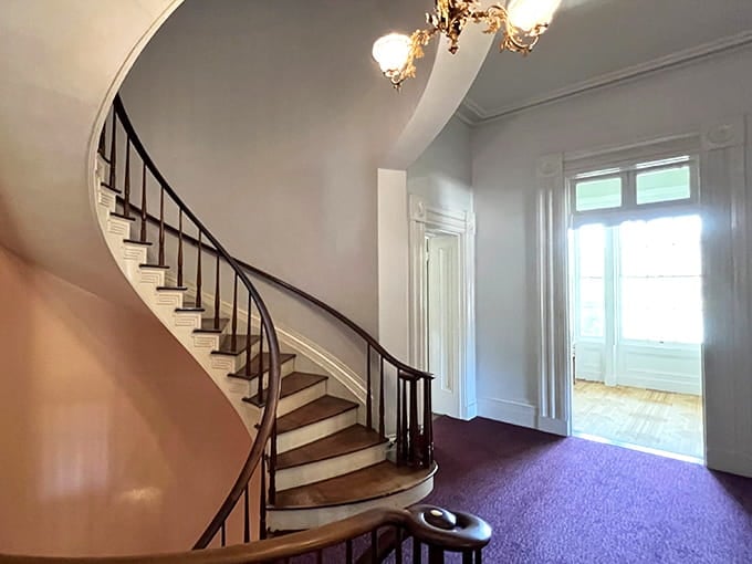 Here's that famous freestanding spiral staircase, curving upward like something M.C. Escher dreamed up after too much coffee.