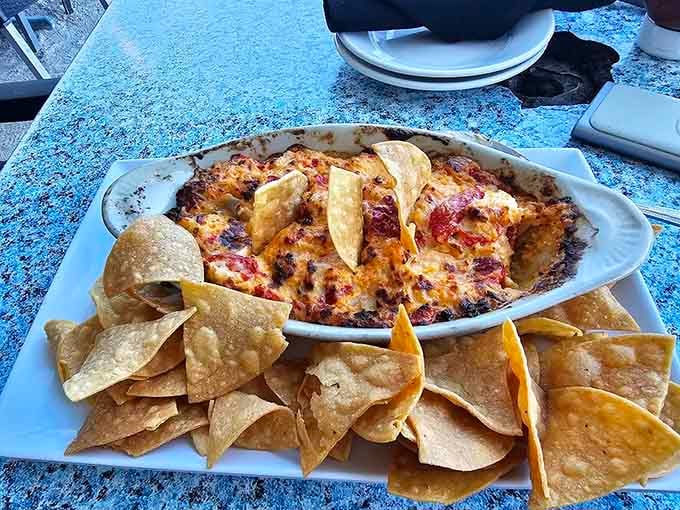 Bubbly hot seafood dip surrounded by chips, creating the kind of appetizer that starts friendly arguments over sharing.