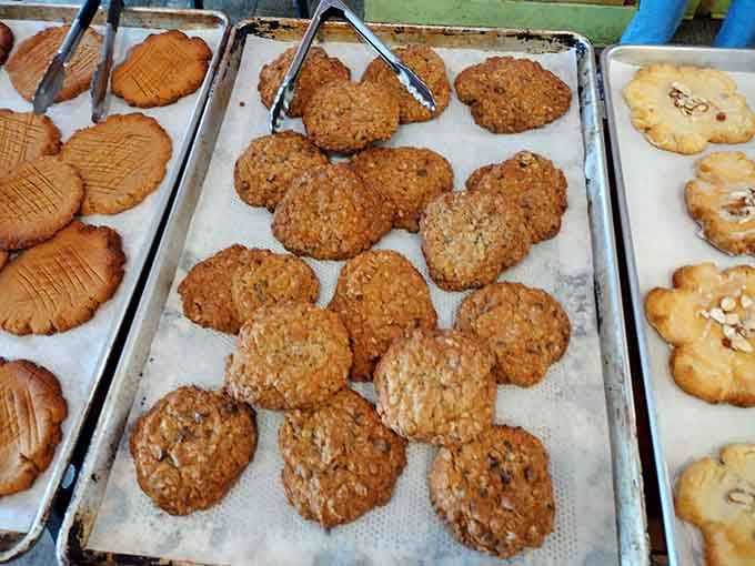 Fresh-baked cookies lined up like edible sunshine, ready to make someone's day infinitely better with every bite.