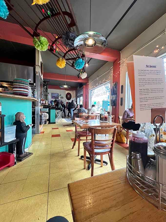 Colorful paper decorations dangle overhead while diners settle in, creating an atmosphere that encourages lingering over coffee refills.