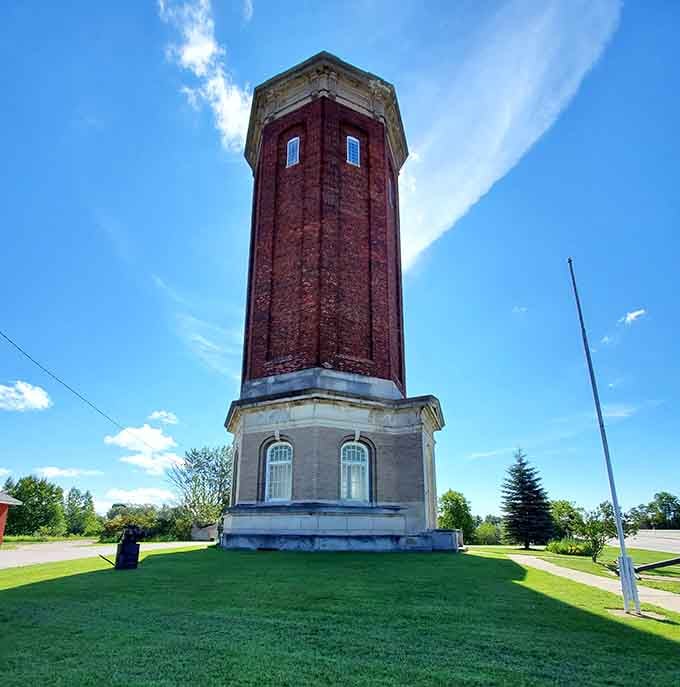 The old water tower stands tall like a proud grandfather, watching over the town it's served faithfully.