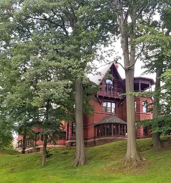 Mature trees frame this literary landmark like nature's own picture frame, adding gravitas to an already impressive Hartford treasure.