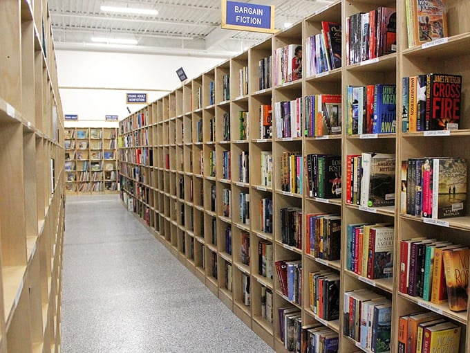 Fiction aisles stretch into the distance, each shelf packed with stories waiting to transport you somewhere magical.
