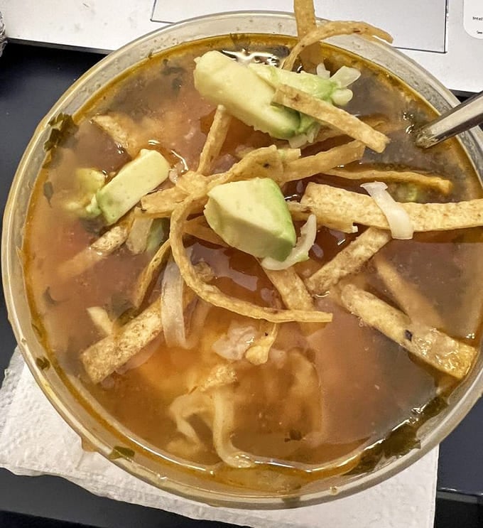 Chicken tortilla soup loaded with crispy strips and avocado proves that comfort comes in many forms, especially in a bowl.
