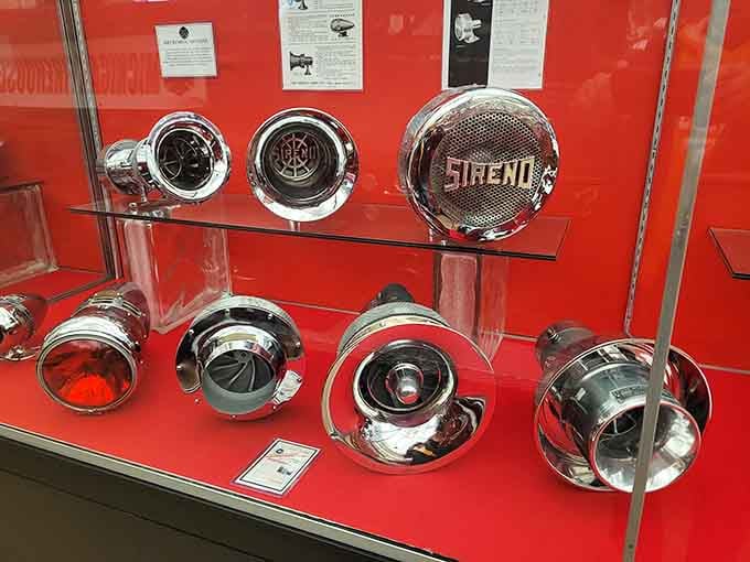 Chrome sirens that once wailed through Michigan streets now gleam quietly behind glass like mechanical jewelry.