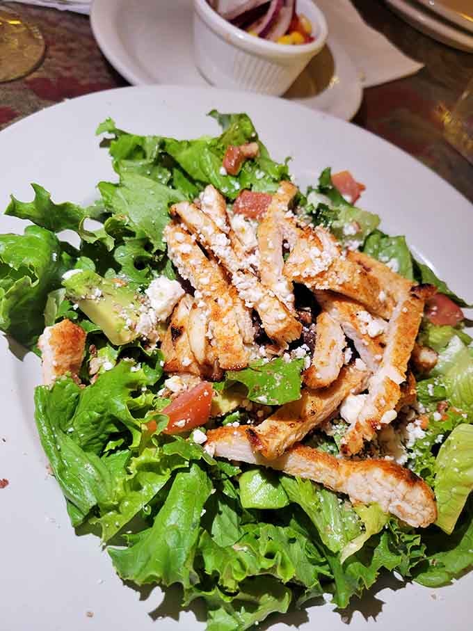 Fresh greens topped with grilled chicken prove that even in a former bordello, virtue has its place on the menu.