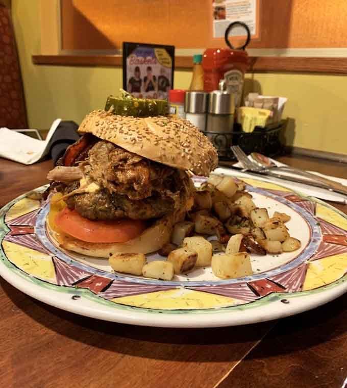The Boom Burger lives up to its name, towering over those home fries like a delicious skyscraper of flavor.