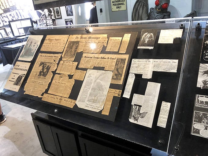 Yellowed newspaper clippings tell the Mothman story as it unfolded in real-time, preserving the growing panic in black and white.