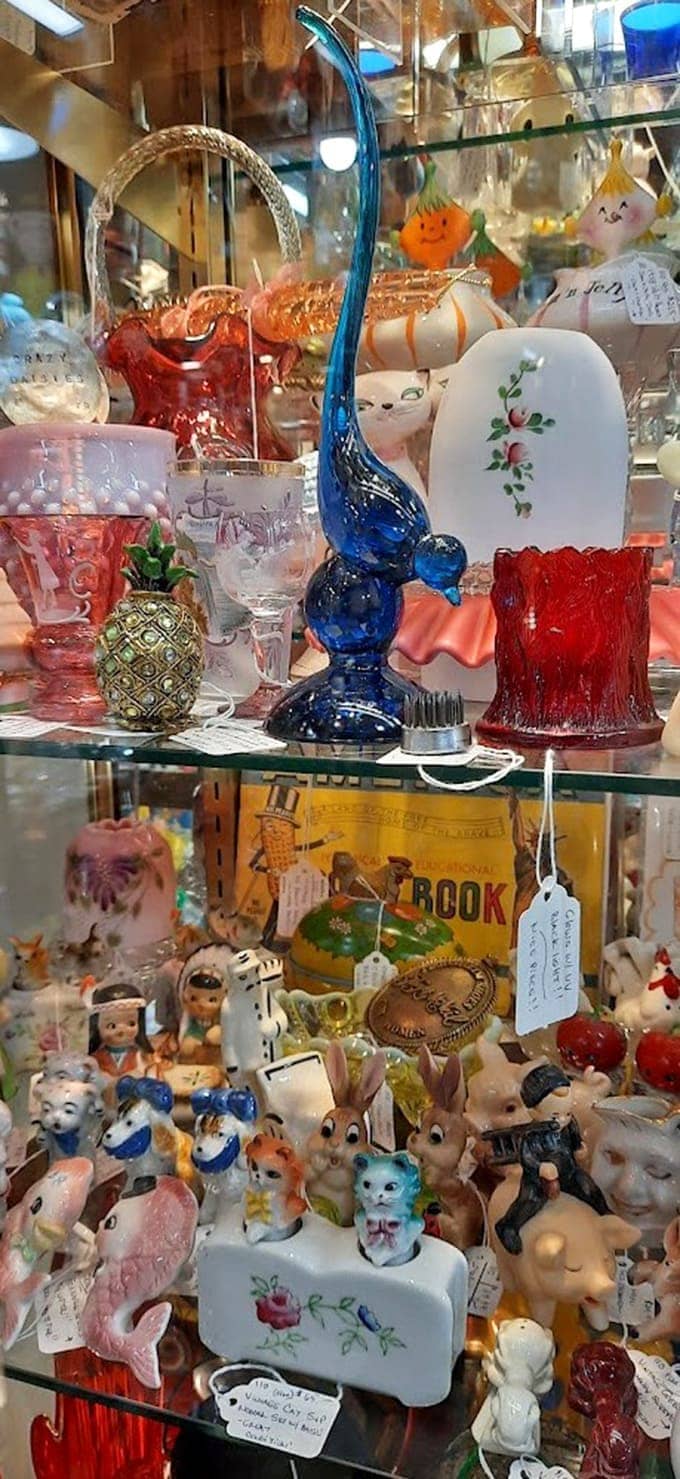 When kitsch meets collectible, magic happens: vintage salt shakers sharing space with elegant blown glass and ceramic treasures.