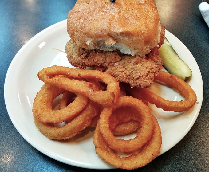 Crispy chicken sandwich with onion rings because sometimes you need to embrace your inner state fair enthusiast.