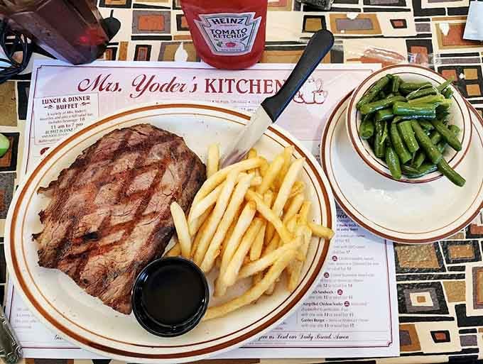 A perfectly grilled steak with fries and green beans, because sometimes Amish Country does steakhouse surprisingly well.