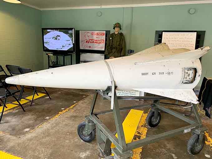 A Nike Hercules missile stands ready, its sleek white body belying the destructive power it once represented for defense.