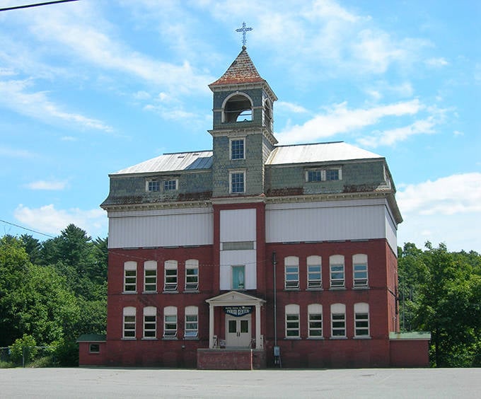 Notre Dame de Lourdes Parish Center's distinctive bell tower reaches skyward, a spiritual landmark that's been bringing the community together for generations.