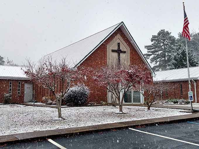 Even light snow transforms this brick church into a Hallmark movie set, where winter is just pretty enough for photos without requiring heavy shoveling.