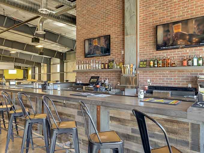 This bar area combines exposed brick charm with racing culture, where post-race debriefs taste better with refreshments nearby.