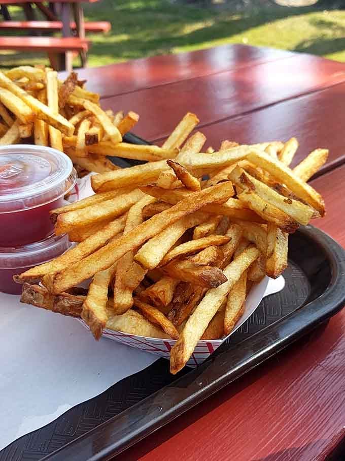 Golden fries piled high and crispy, proving that sometimes the simplest pleasures are truly the most satisfying ones.